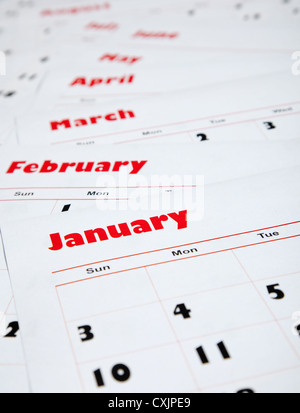 Stack of monthly calendars with red ink Stock Photo - Alamy