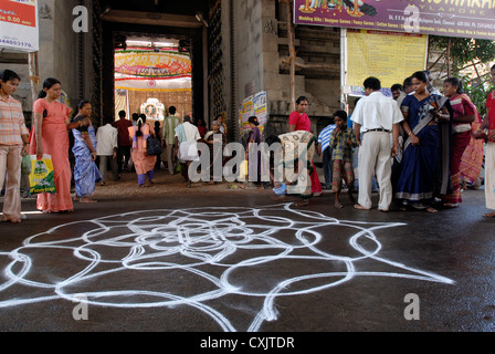 Chennai woman is making an Rangoli design with Flowers in an Indian ...