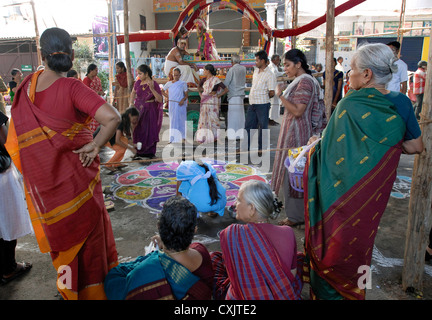 Chennai woman is making an Rangoli design with Flowers in an Indian ...