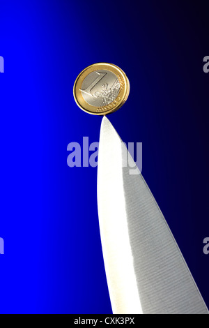 Euro Coin on Knife Edge Stock Photo - Alamy