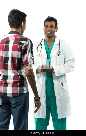Happy Asian women doctor talking on mobile phone gesturing while ...