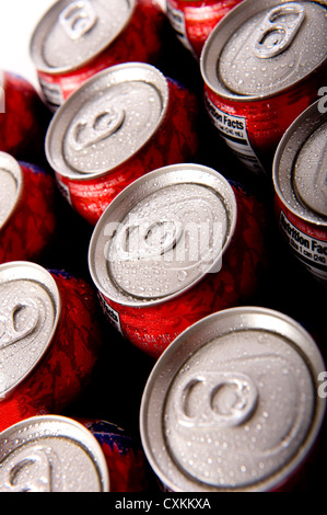 Cans of ice cold soda and water in a container of ice are sold by an ...