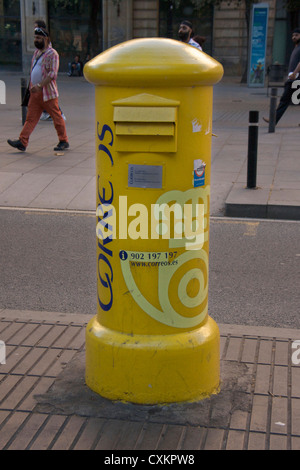 Yellow Spanish post box of the national postal service, Correos, in ...
