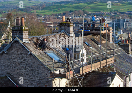 Builders working on house roof. Beast Banks, Kendal, Cumbria, England ...