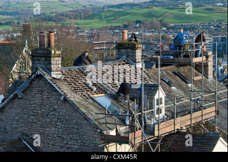 Builders working on house roof. Beast Banks, Kendal, Cumbria, England ...