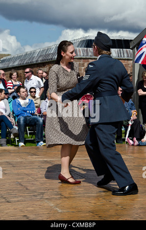 Couple in WW2 period clothes dancing the jitterbug at an historic Stock ...