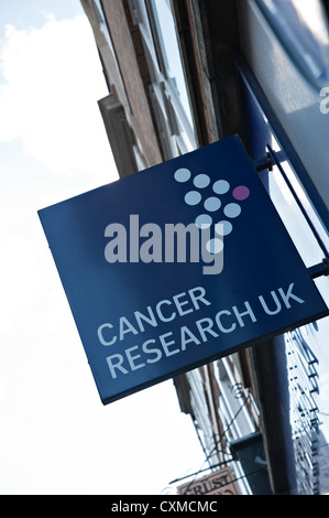 Cancer research UK sign with logo on charity shop UK Stock Photo - Alamy