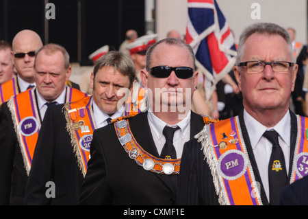 A number of orangemen wearing traditional 'Orange sash' and bowler hats ...