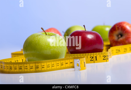 Red apples with a yellow tape-measure Stock Photo - Alamy
