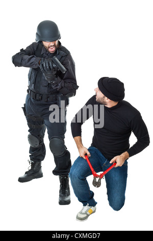 a scared burglar busted by a swat or police officer Stock Photo - Alamy