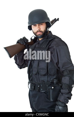 a swat agent wearing a bulletproof vest and aiming with a gun Stock ...