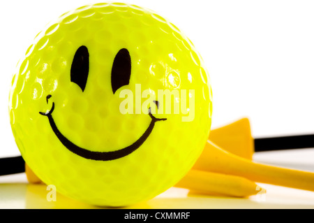 Golf tee and a yellow smiley face golf ball on a white background Stock ...