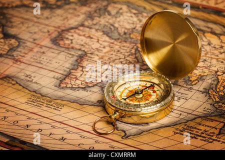 Old vintage retro golden compass on ancient map Stock Photo - Alamy