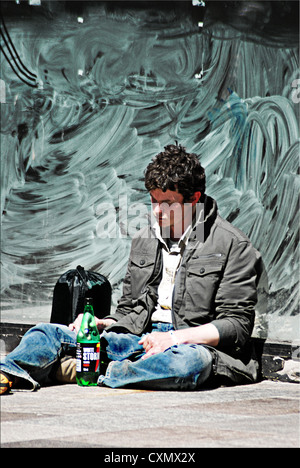 Alcoholic homeless man drinking on street Stock Photo - Alamy