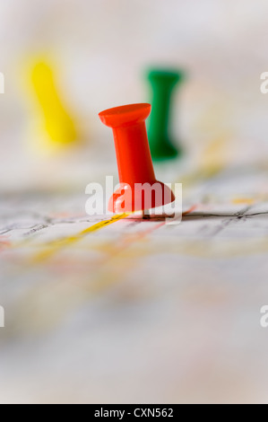 Pushpin on map pinpointing a particular area, map in not ...