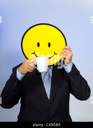 Smiley face man drinking a cup of coffee Stock Photo - Alamy