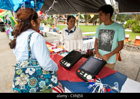 Voter registration booth at an outdoor church festival in Austin, Texas ...