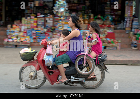 Girl riding pillion on a motor bike Stock Photo - Alamy