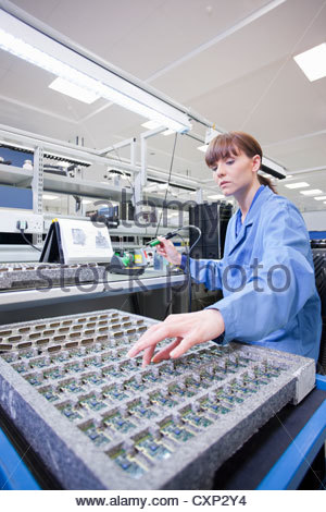 Technician working on assembly line in hi-tech electronics Stock Photo ...