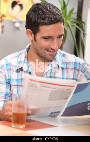 Man drinking iced fruit tea with straw in cafe interior. Urban ...