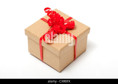 Brown gift box with a red ribbon on dark background Stock Photo - Alamy