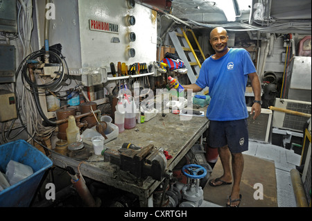Machinist working in the engine room of a ship, Okeanoss Aggressor ...