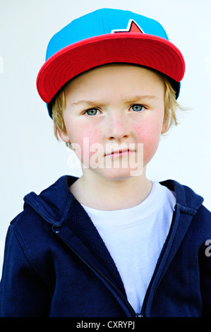 A 10-year-old boy wearing an inexpensive souvenir Indian headdress and ...