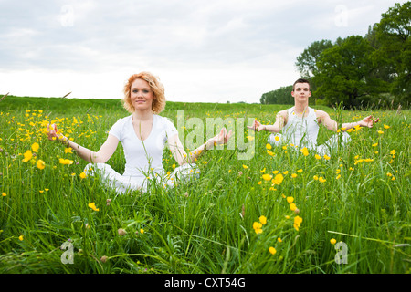 Smiling Couple relaxing doing yoga together at home together Stock ...
