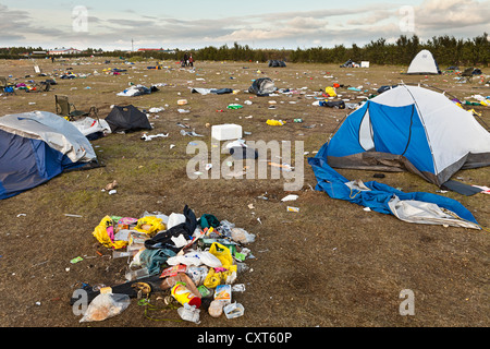 Meadow full of garbage, waste, destroyed tents and broken camping ...