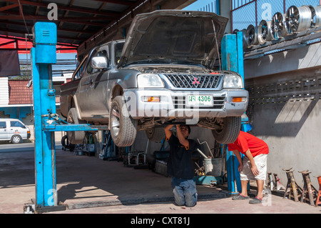 Mechanics Working on repairing mending a Banger Racing Car vehicle ...