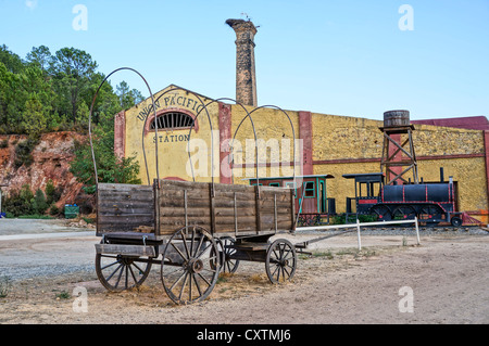 Old Wild West train with mining carts passing over an old wooden bridge ...