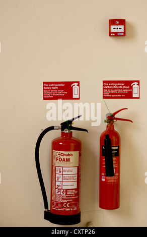 Two Chubb Fire extinguishers mounted on a wall, one water with Additive ...