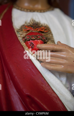 Closeup of statue of Jesus pointing to his heart Stock Photo - Alamy