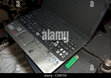 Burnt melted laptop computer fire electrical fault Stock Photo - Alamy