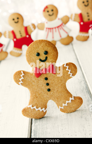 Gingerbread men in a line, red ribbon Stock Photo - Alamy