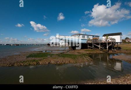 Boats at low tide at West Mersea, Mersea Island, near Colchester, Essex ...