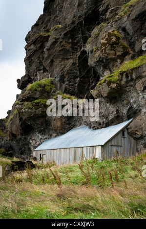 Barn built next to a rock, Austurland, eastern Iceland, Iceland, Europe ...