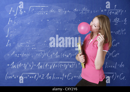 University student blowing bubblegum in classroom, Bavaria, Germany ...