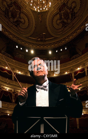 Conductor with baton in concert hall, closeup Stock Photo - Alamy