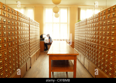 Students in a university library at filing cabinet Stock Photo - Alamy
