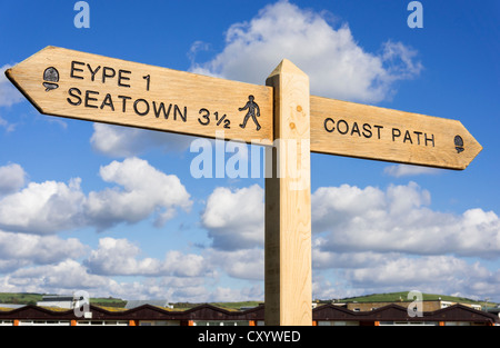 Wooden sign post along the South West Coast Path with directions to ...