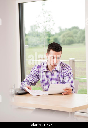 Woman working with documents at desk in office Stock Photo - Alamy