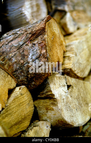 Firewood pile stacked chopped wood trunks, close-up wooden background ...