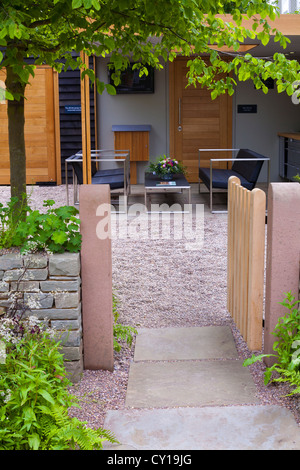 Backyard area of contemporary house with table and chairs in patio ...