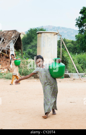 Rural Indian village girls collecting water from a communal water Stock ...