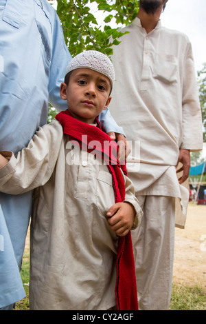 Muslim boy in traditional dress with father and his prayer beads, Al ...