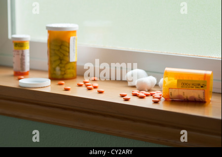 Pills and pill bottles along window sill with mirror Stock Photo - Alamy
