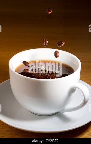 Coffee splash and roasted beans in air on white background Stock Photo ...