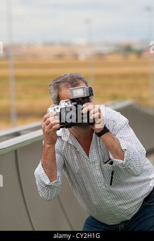 Happy senior man taking pictures with camera Stock Photo - Alamy
