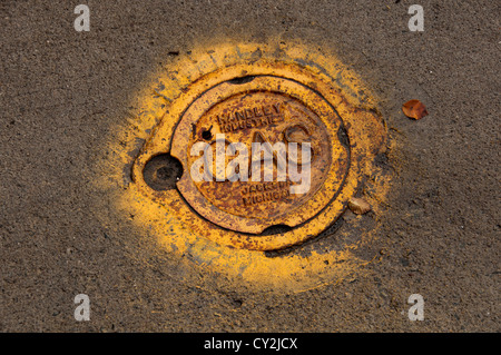 Gas utility manhole cover with yellow paint on asphalt, top view Stock ...